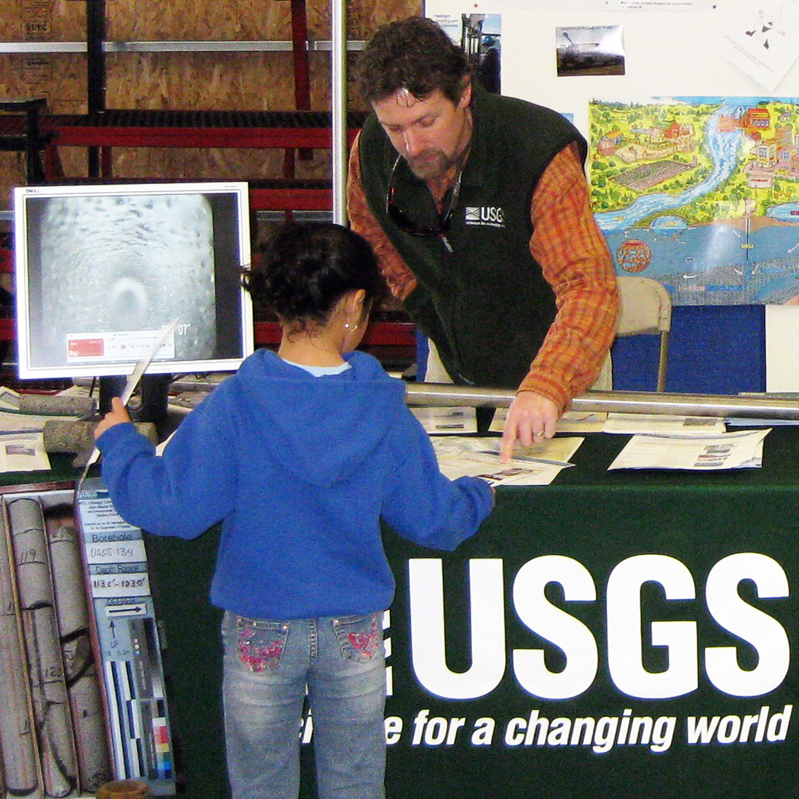 USGS Scientist Talking With A Child At A Public Outreach Event U S