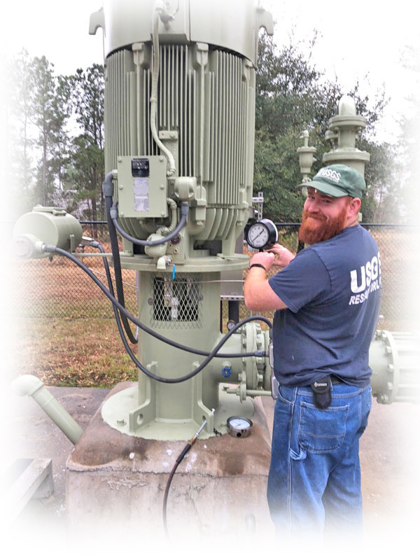 USGS hydrologic technician measuring a well in Montgomery County, Tex ...
